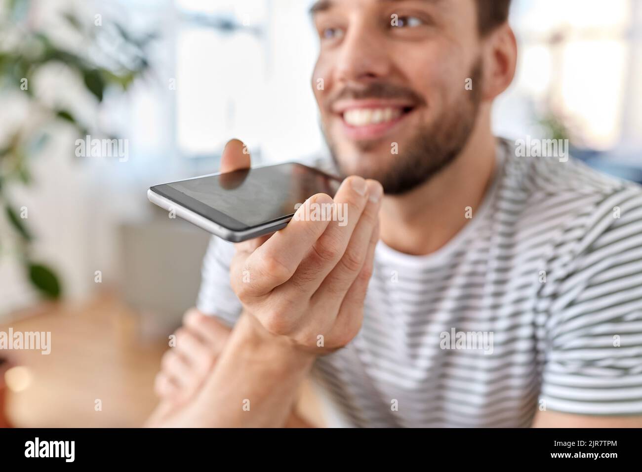 man calling or recording voice with phone at home Stock Photo - Alamy