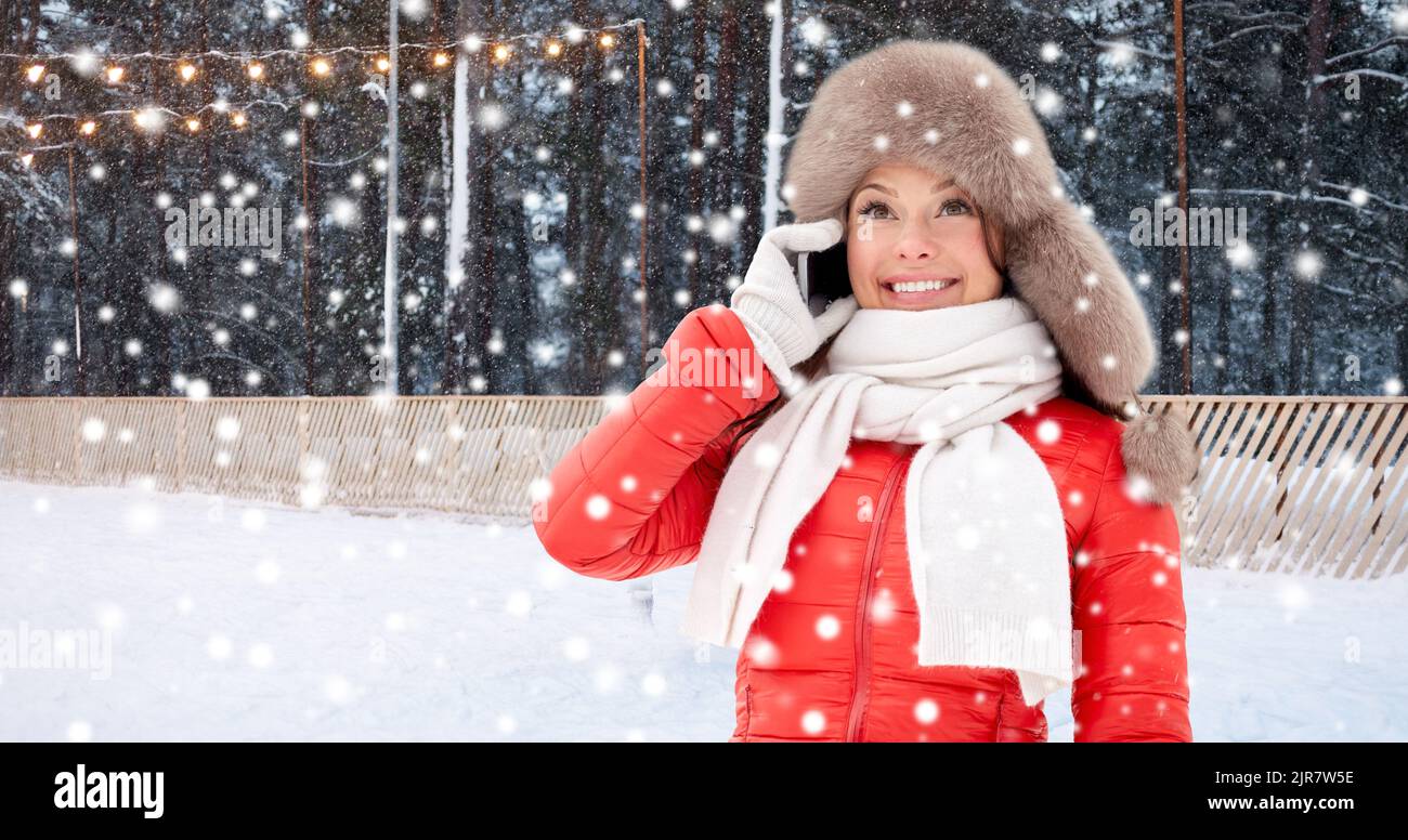woman calling on smartphone over ice skating rink Stock Photo - Alamy