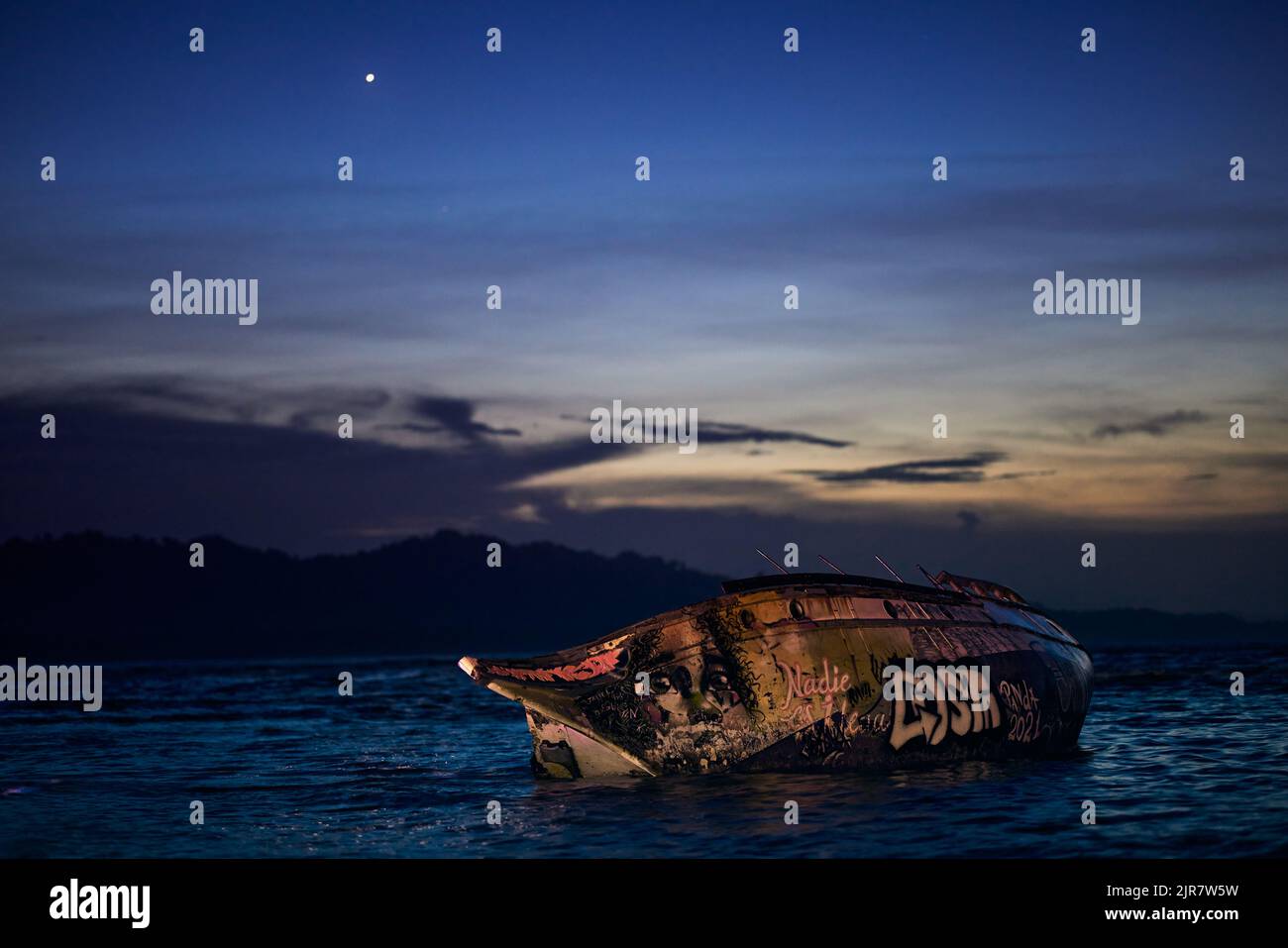 A night view of a sinking boat in Puerto Viejo, Coast Rica Stock Photo ...