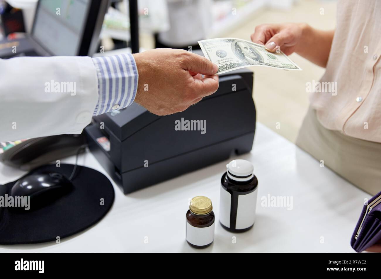pharmacist taking money from customer at pharmacy Stock Photo - Alamy