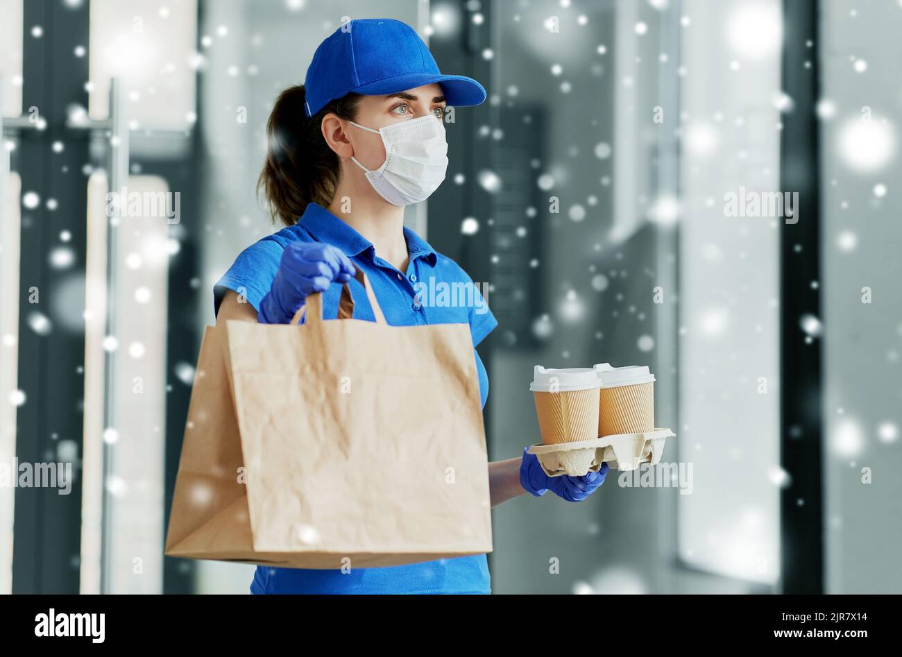 delivery woman in face mask with food and drinks Stock Photo - Alamy