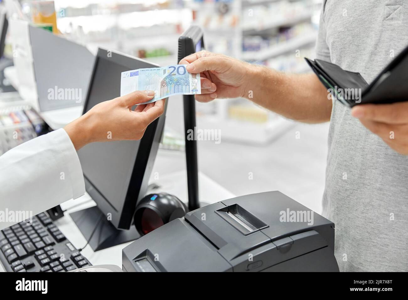 pharmacist taking money from customer at pharmacy Stock Photo - Alamy