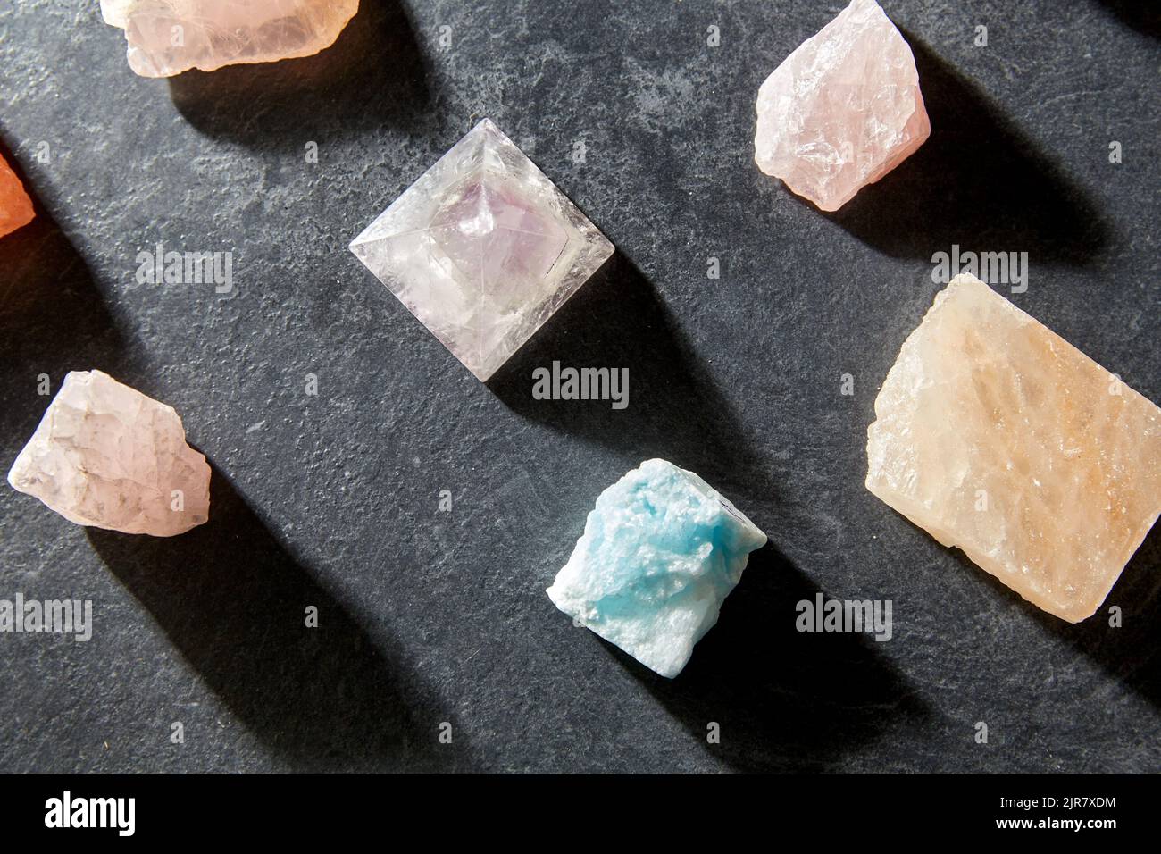 quartz crystal pyramid and gem stones on slate Stock Photo - Alamy
