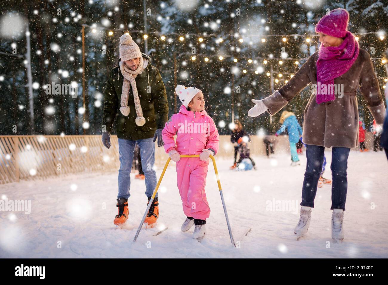 happy family at outdoor skating rink in winter Stock Photo - Alamy