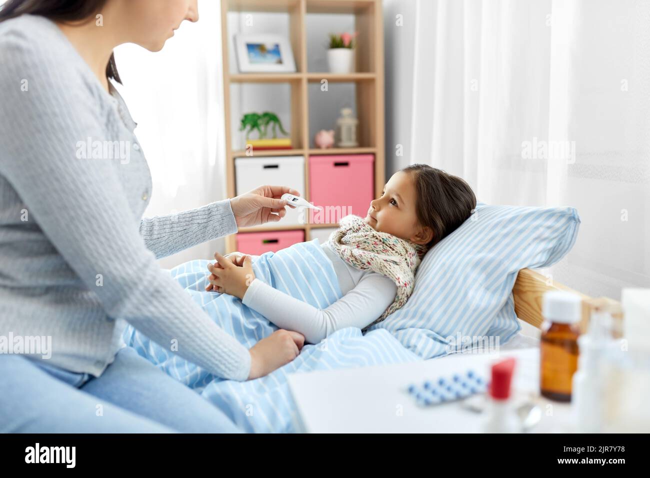 mother measuring temperature of sick daughter Stock Photo - Alamy