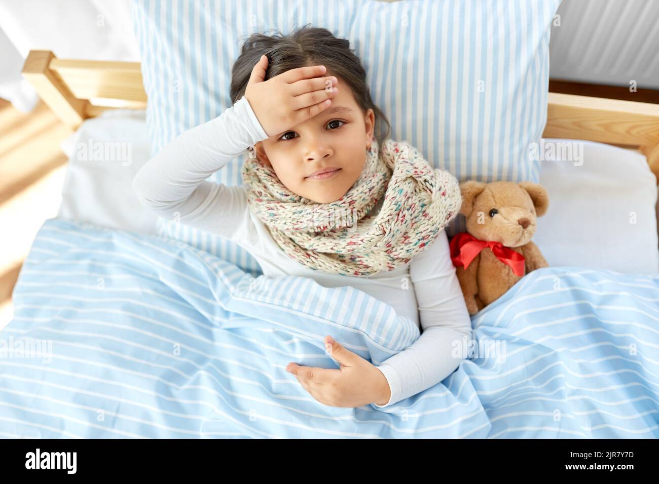 sick girl lying in bed at home Stock Photo - Alamy