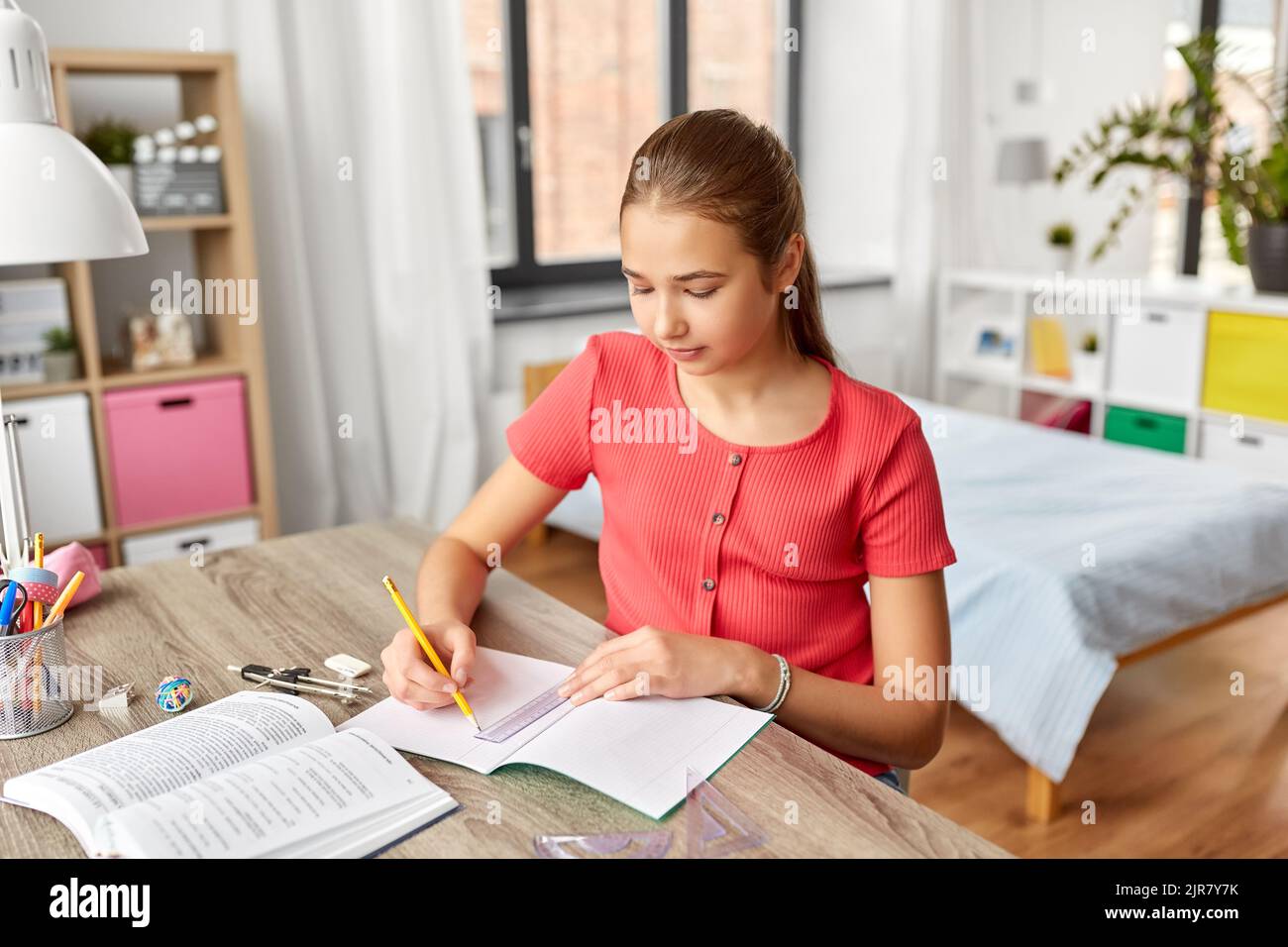 student girl with ruler drawing line in notebook Stock Photo - Alamy