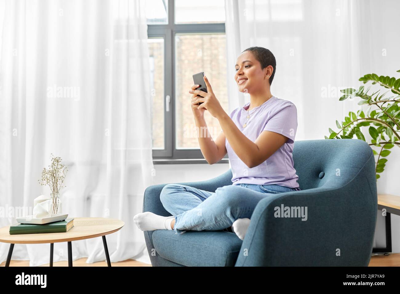 african american woman with smartphone at home Stock Photo - Alamy