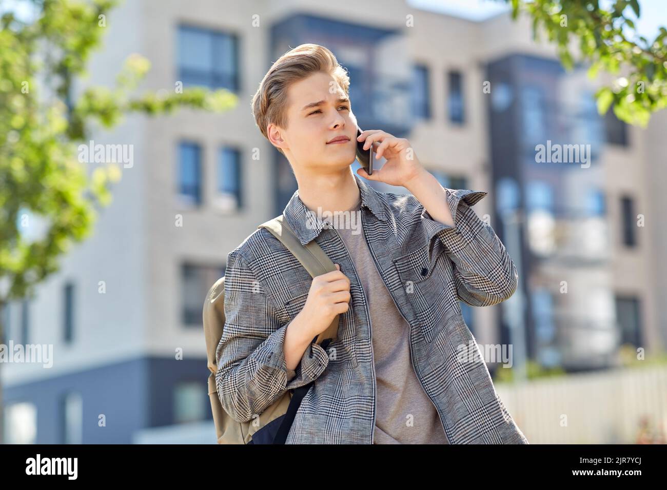 Boy talking on his mobile in school hi-res stock photography and images ...