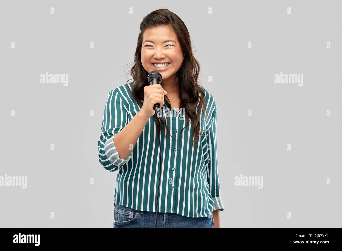 happy asian woman with microphone singing Stock Photo - Alamy