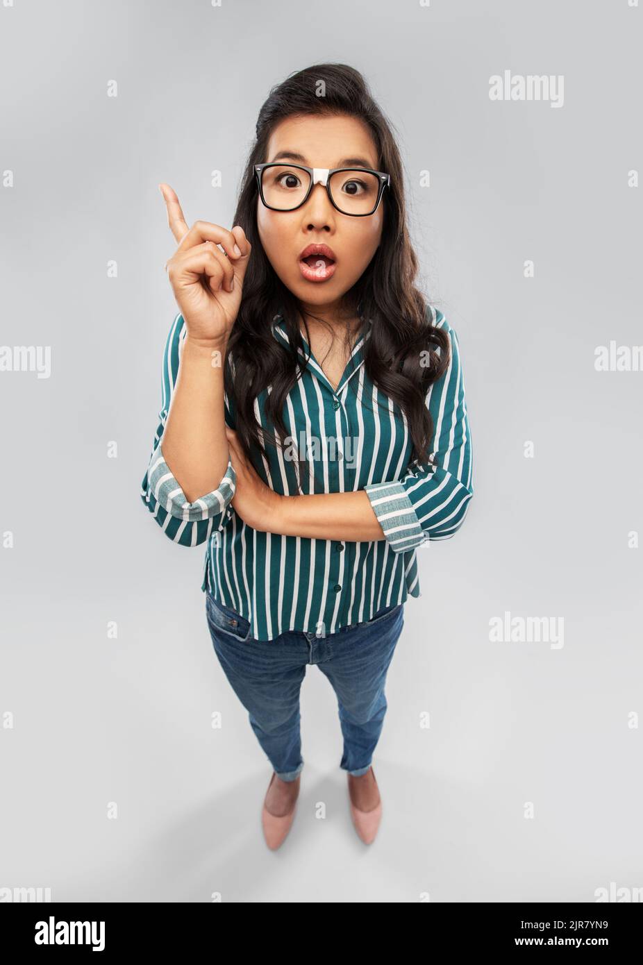surprised asian student woman pointing finger up Stock Photo - Alamy