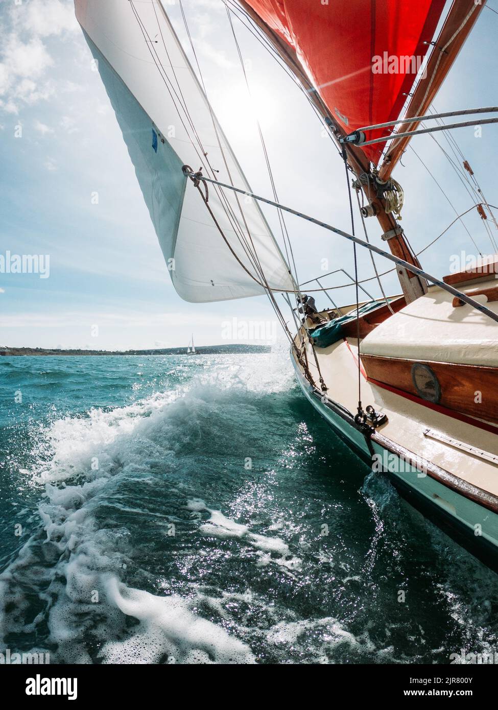 A classic sailing yacht slanting in the sea Stock Photo - Alamy