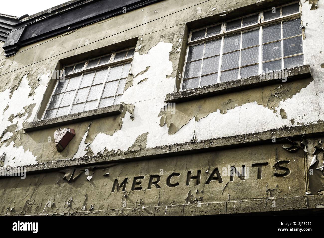 The exterior design of an old building with damaged wall and the paint ...