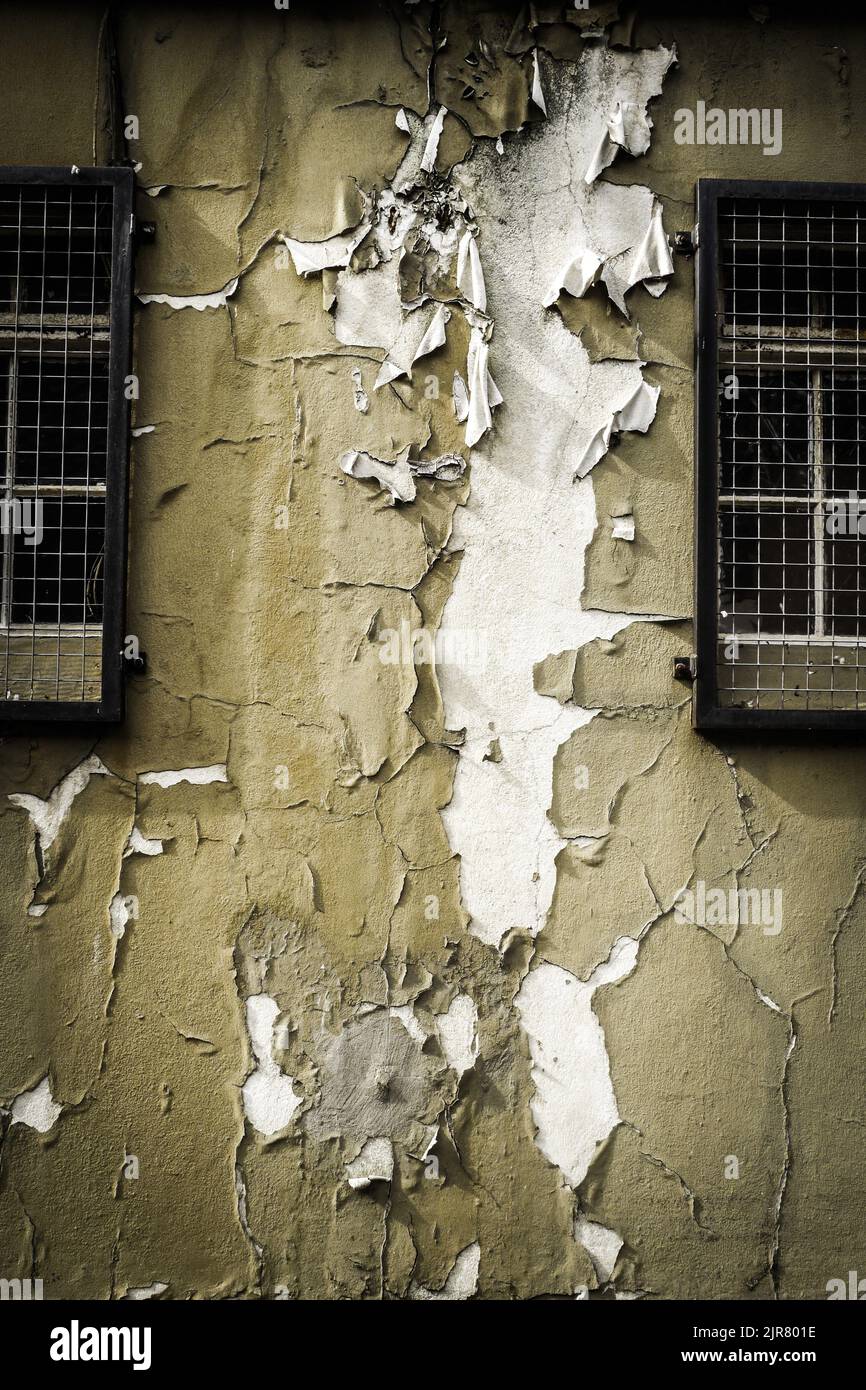 The exterior design of an old building with damaged wall and the paint ...
