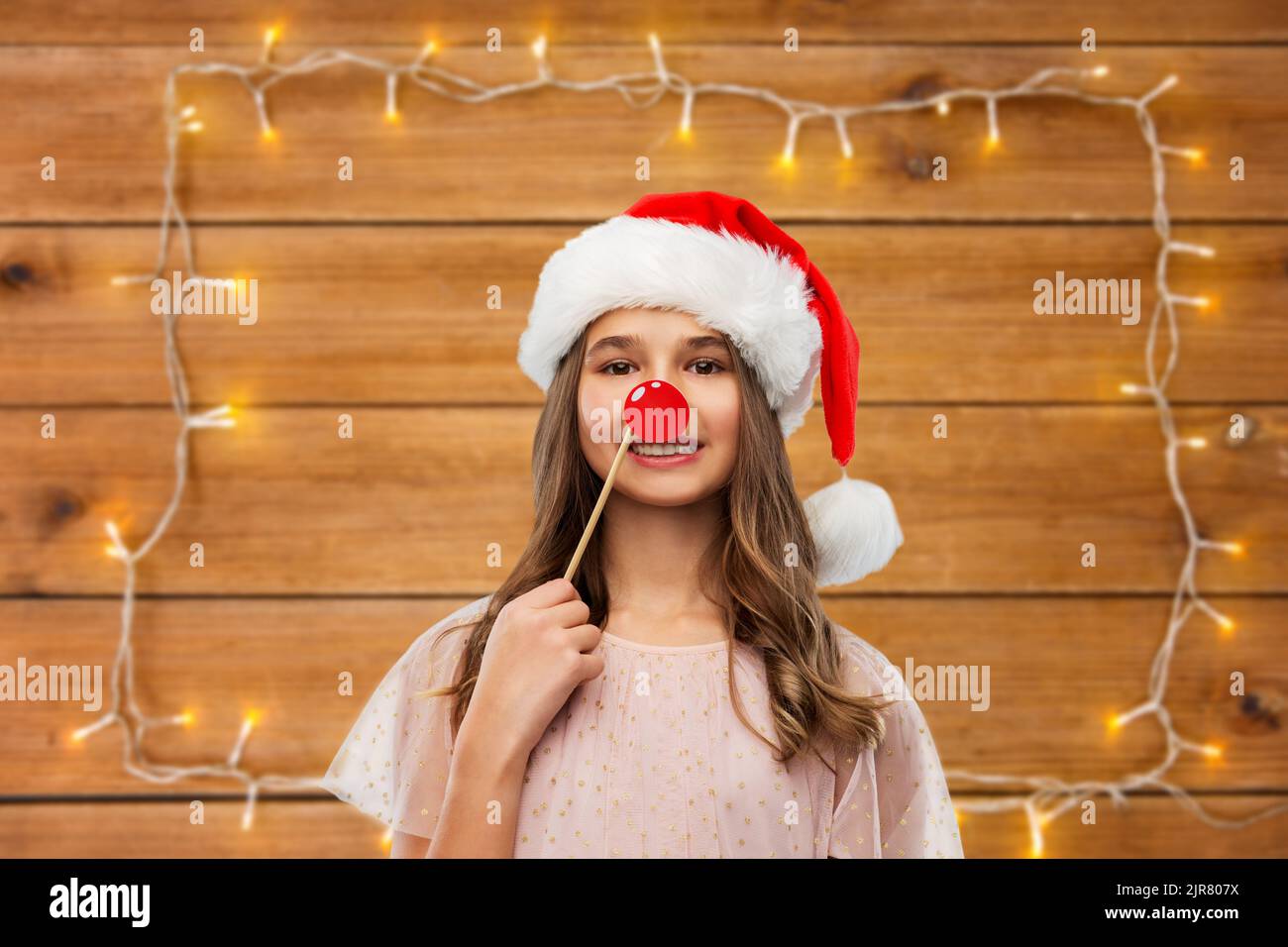 happy teenage girl in santa hat on christmas Stock Photo - Alamy