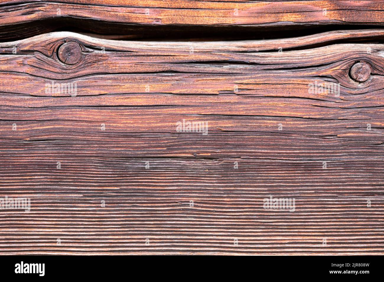 Macro shot of an ancient weathered dark brown cracked wood beam surface ...