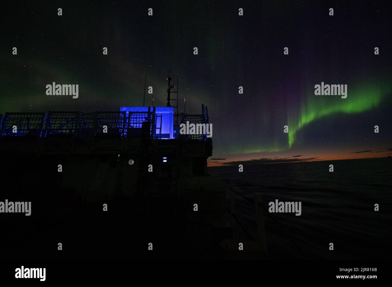 The aurora borealis is seen, with lingering sunlight at 0130 in the ...