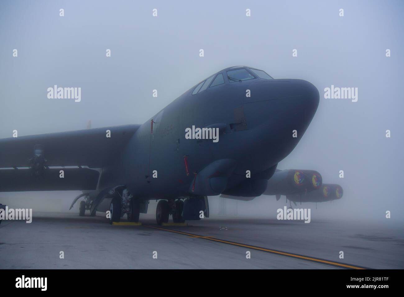A B-52H Stratofortress sit parked in the fog on the flight line at ...