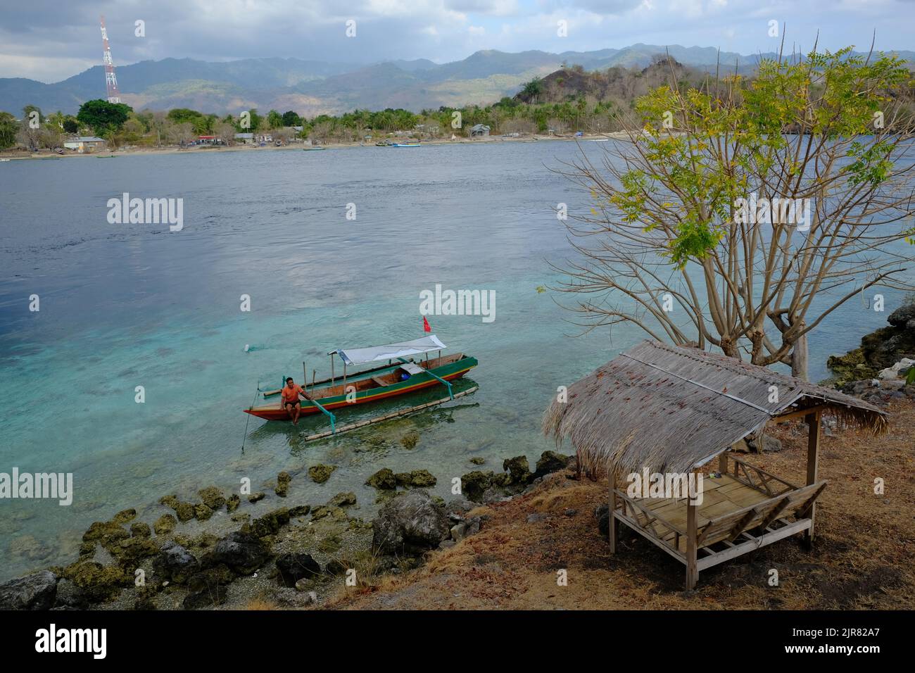 Indonesia Alor Island - Coastal landscape with outrigger fishing boat ...
