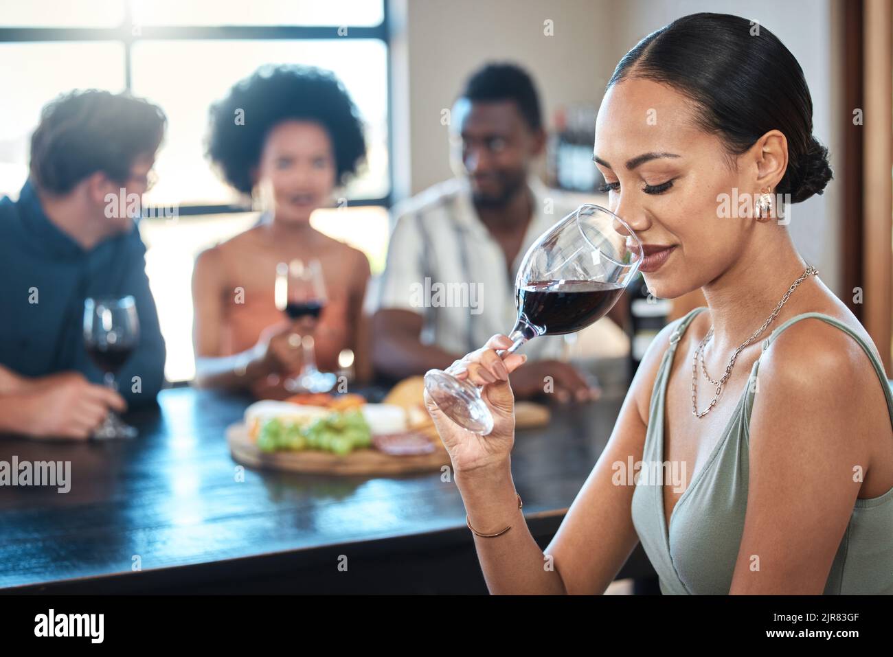Woman with glass of luxury red wine or quality alcohol drinking in food ...