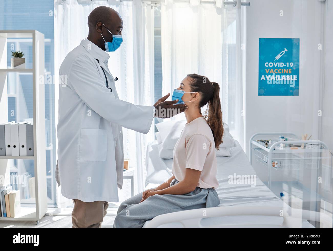 Covid doctor feeling patient thyroid gland, throat and neck for test ...