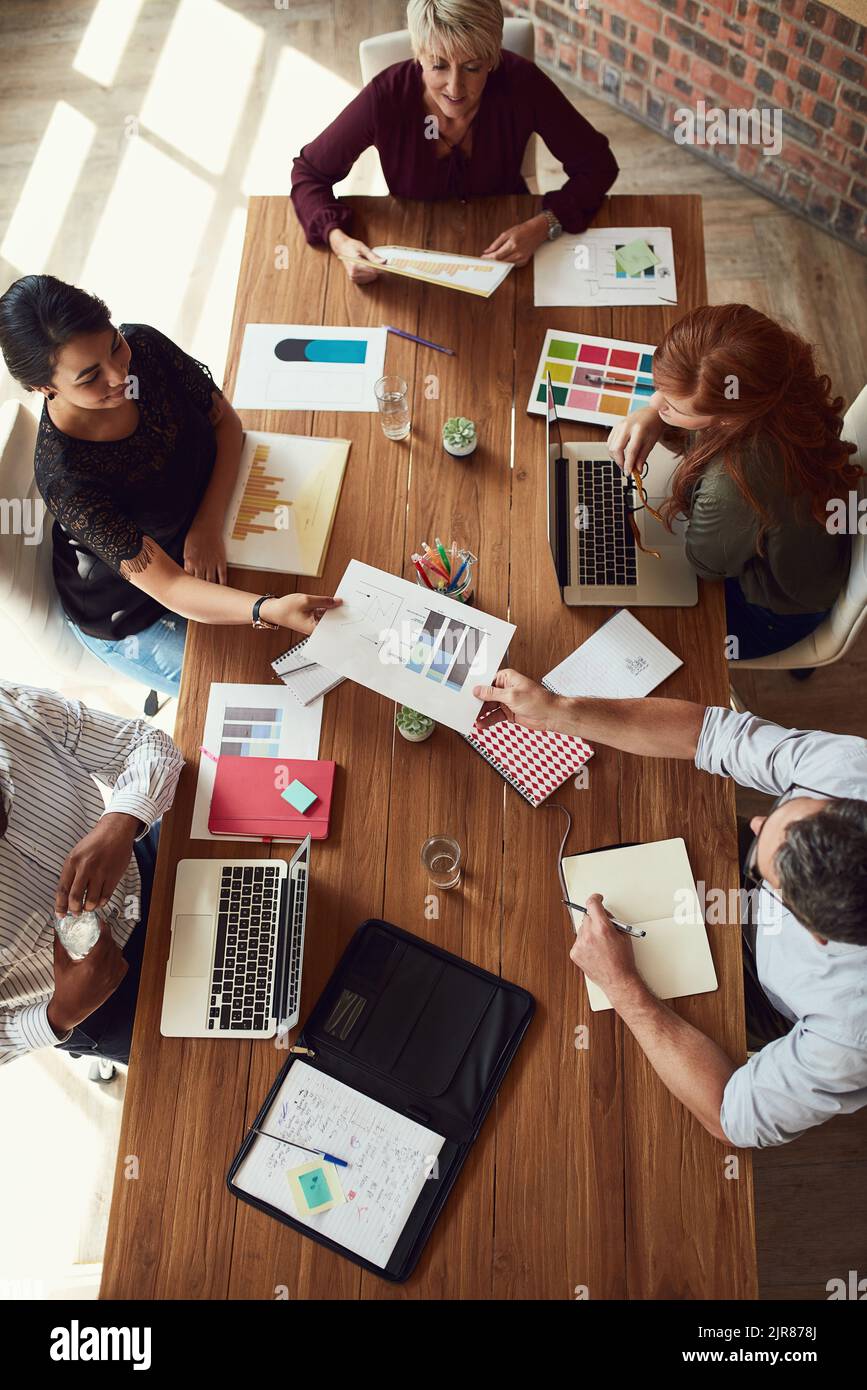 Working in a cooperative environment. High angle shot of a group of ...