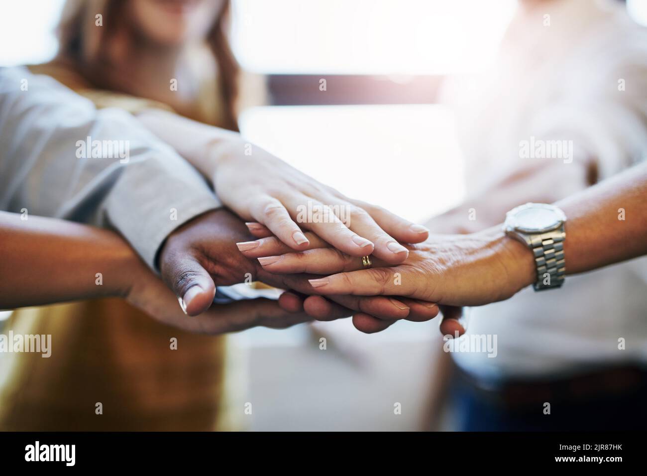 Many hands make light work. a group of unrecognizable colleagues ...