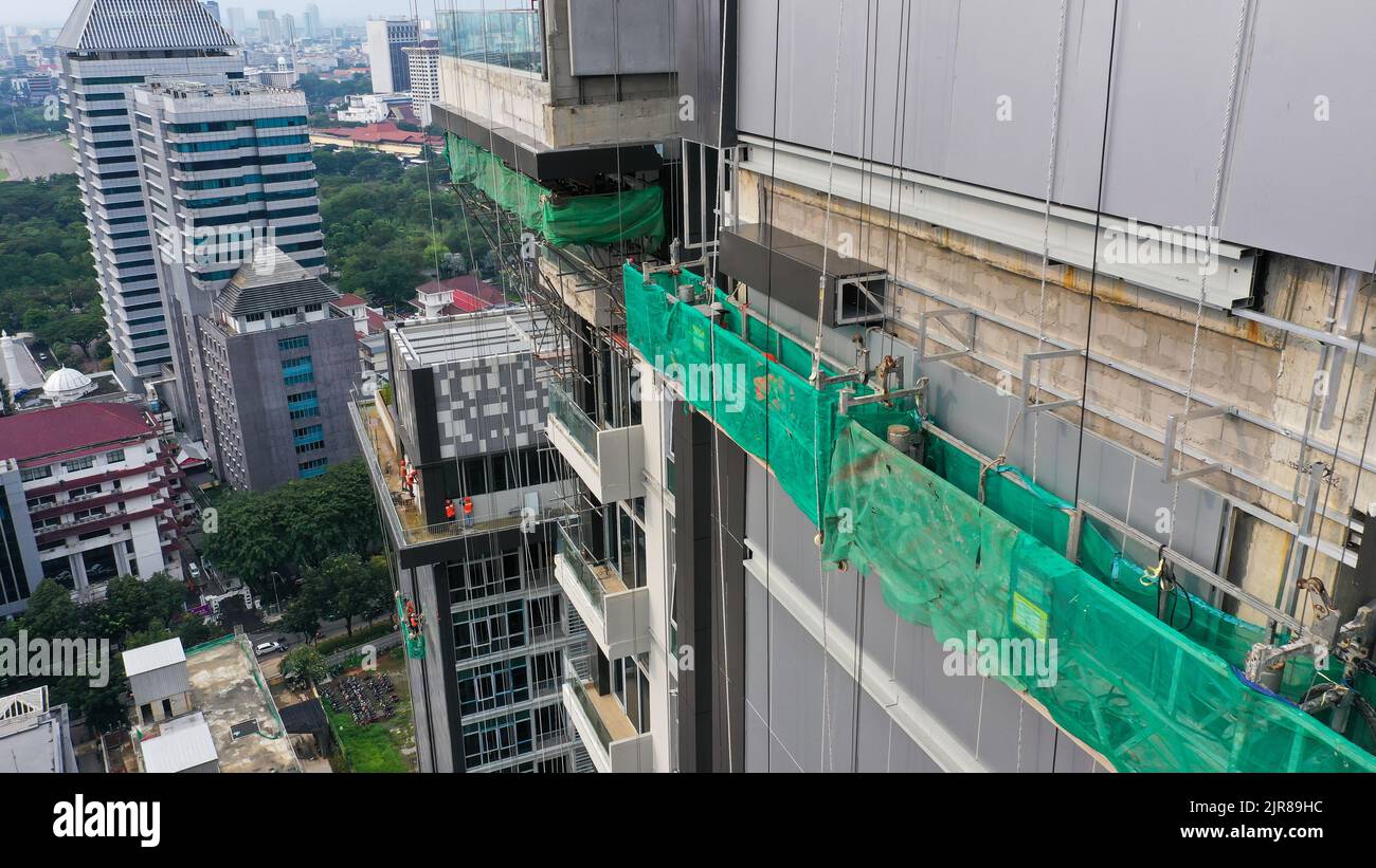 Workers are using gondola as vertical trasport to install aluminum ...