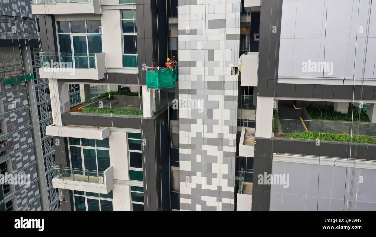 Workers are using gondola as vertical trasport to install aluminum ...