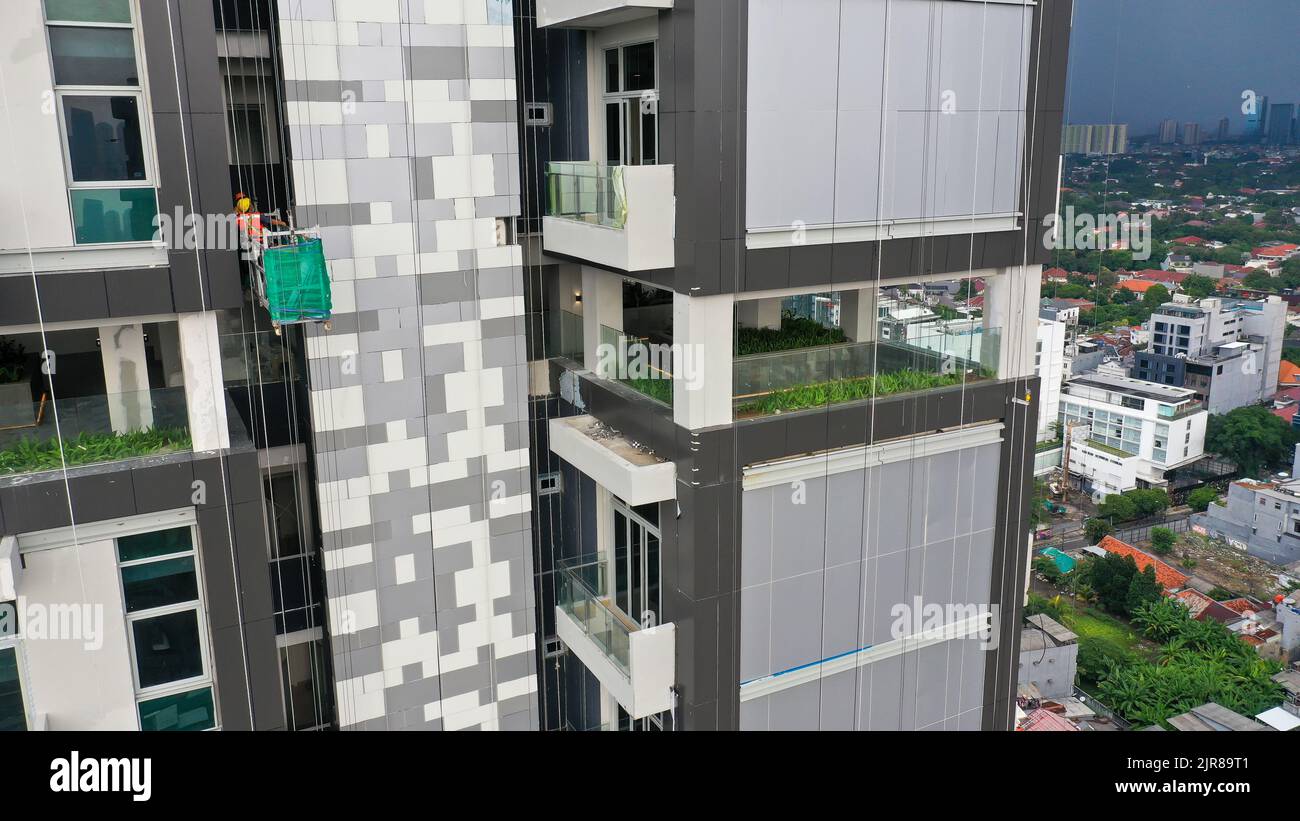 Workers are using gondola as vertical trasport to install aluminum ...