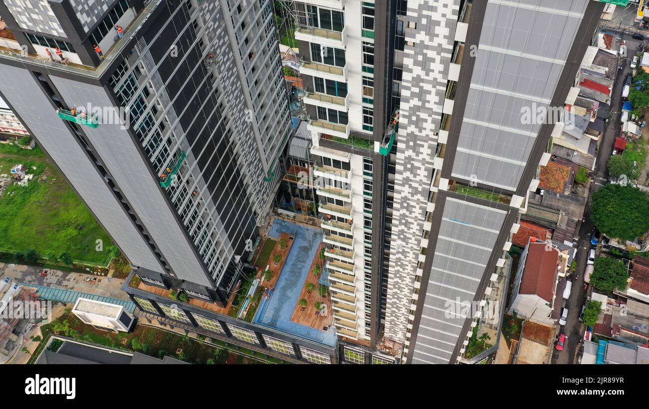 Workers are using gondola as vertical trasport to install aluminum ...