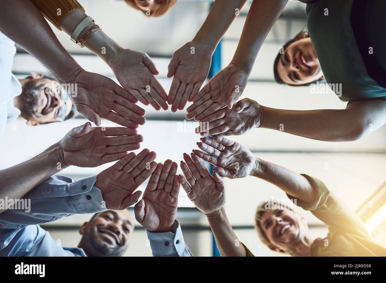 Get hands on in the pursuit of success. Low angle shot of a group of ...