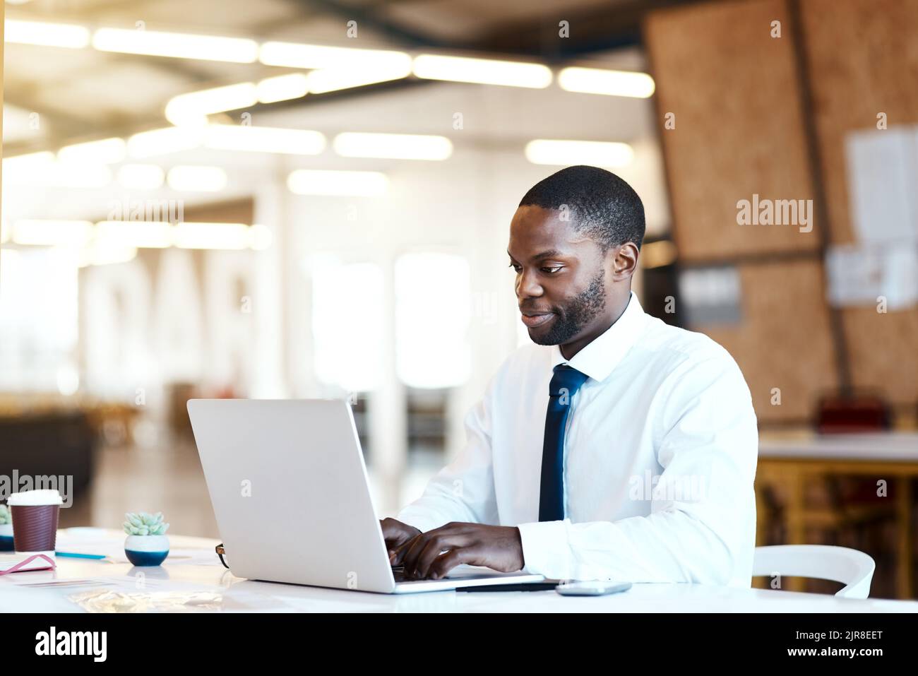 Its going to be a long day. a focused young businessman typing on his ...