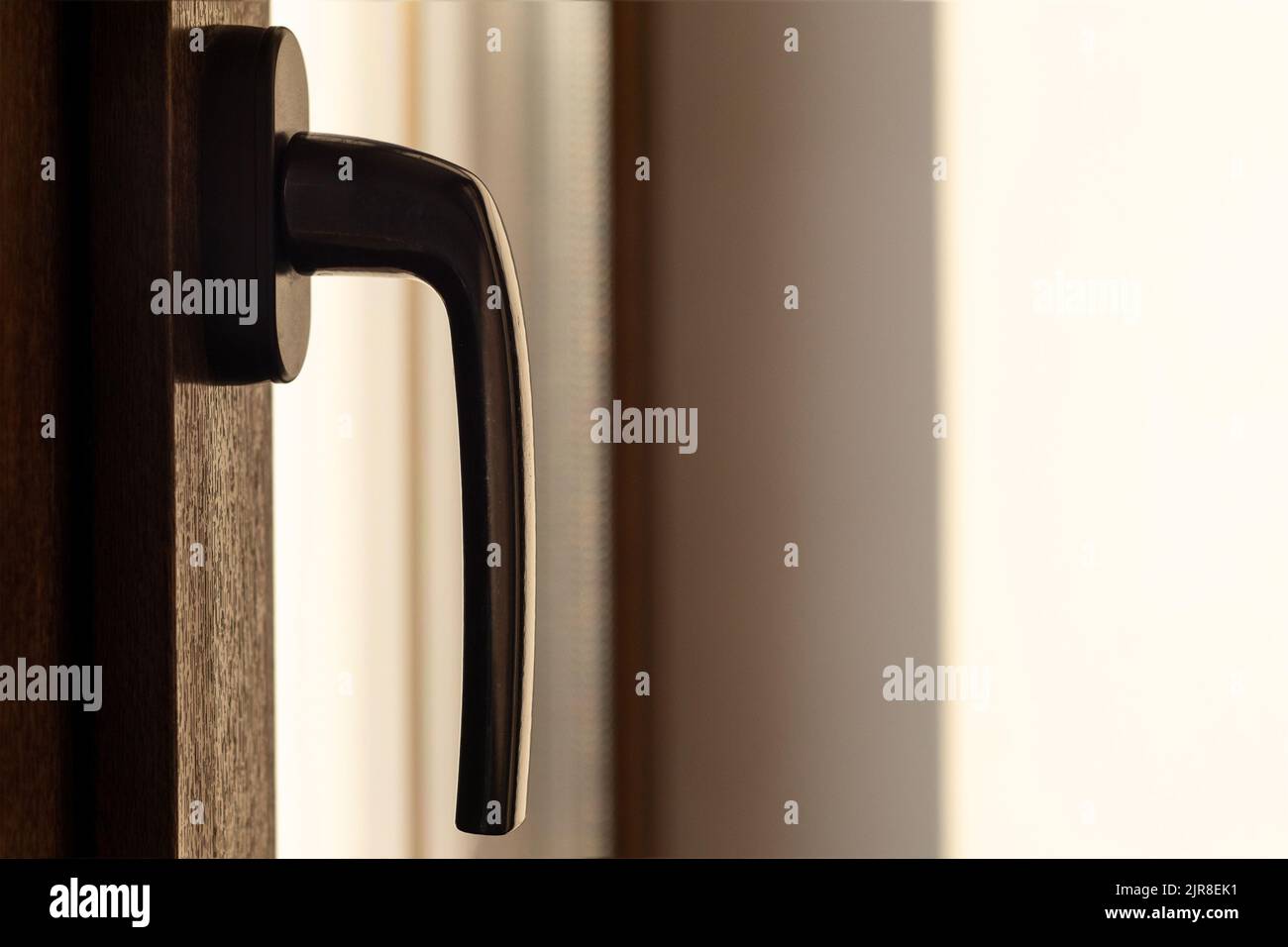 Window handle on a brown metal-plastic window, side view Stock Photo ...