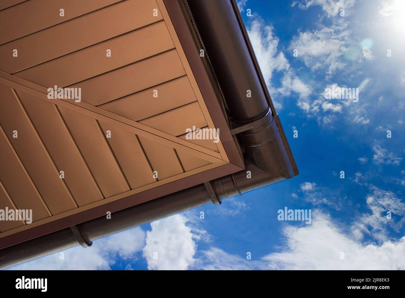 Bottom view on Roof gutter pipeline sysem on corner of house against ...