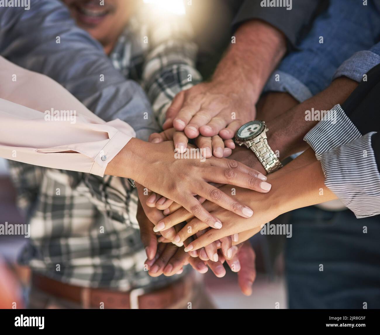 Stacking their hands in a teamwork hi-res stock photography and images ...