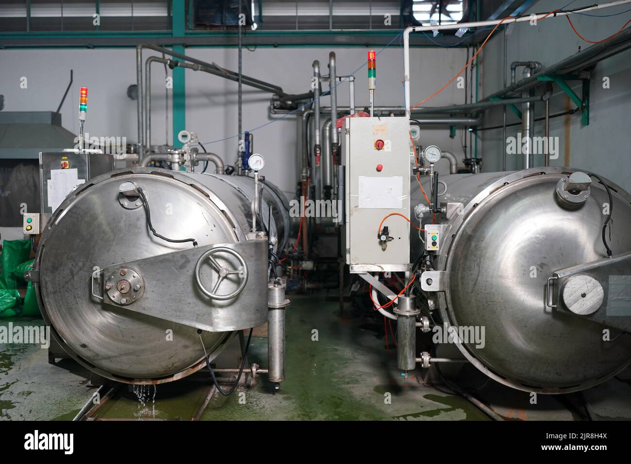 View of reservoires and soft drinks factory interior. worker ...