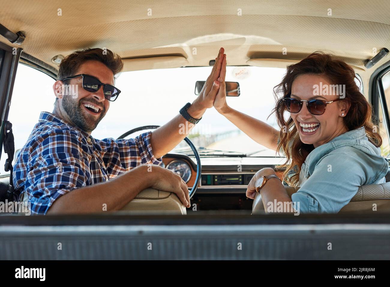 We have arrived. Rearview portrait of an affectionate couple giving ...