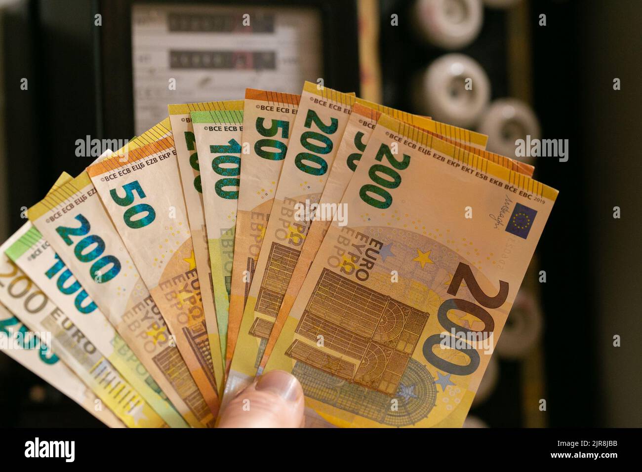 Electricity cost in European countries.Hand holding euro bills on ...