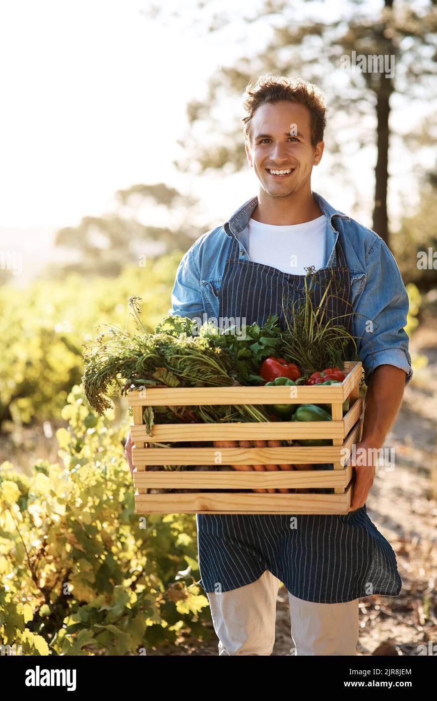 Stop talking and start farming. a young man holding a crate full of ...