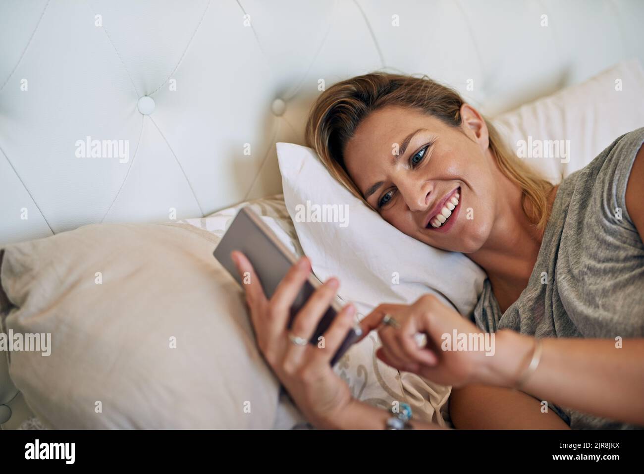 Great sleep and even greater news. an attractive woman smiling and ...
