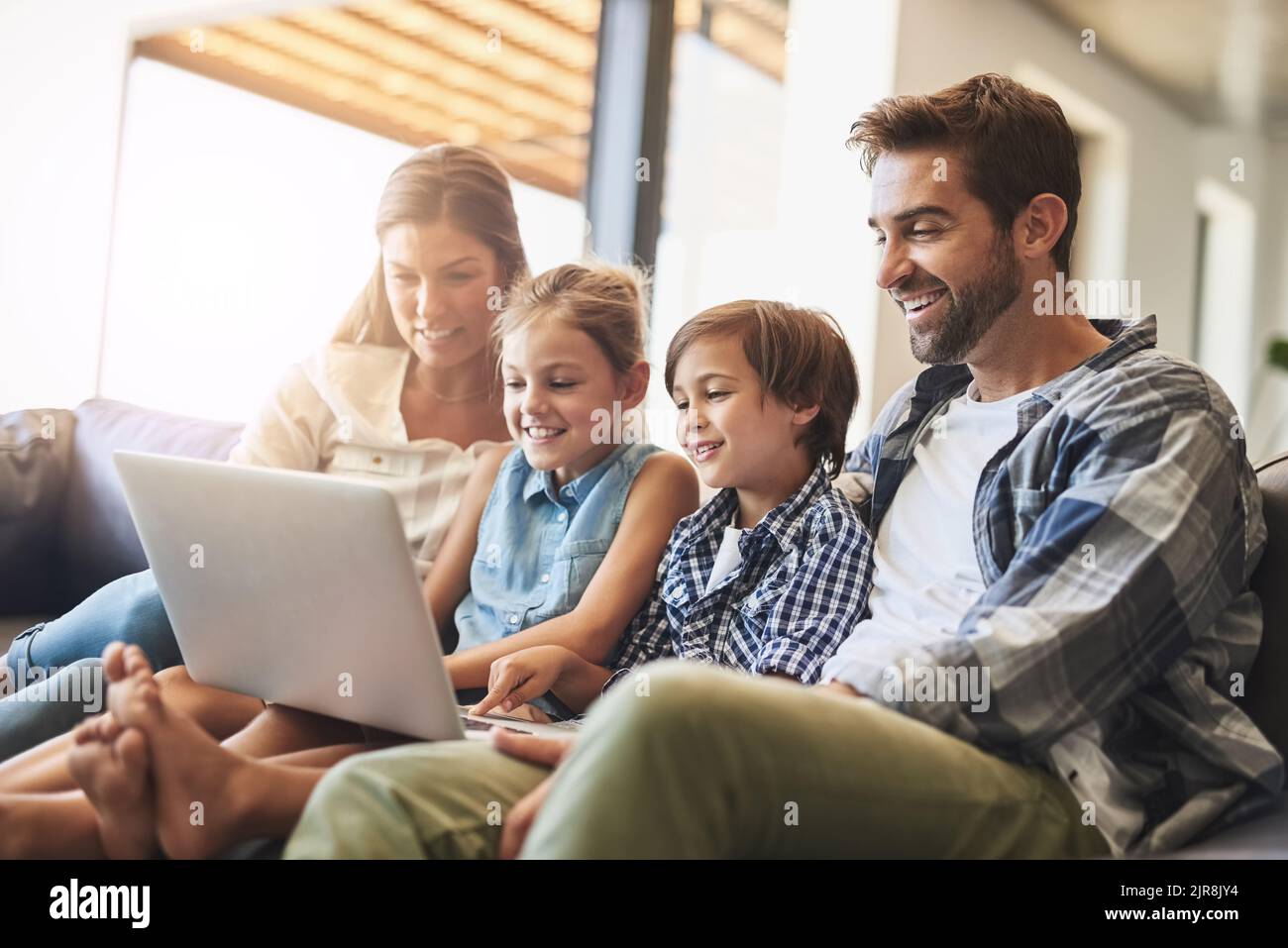 Theyre one tech savvy family. a mother and father using a laptop with ...