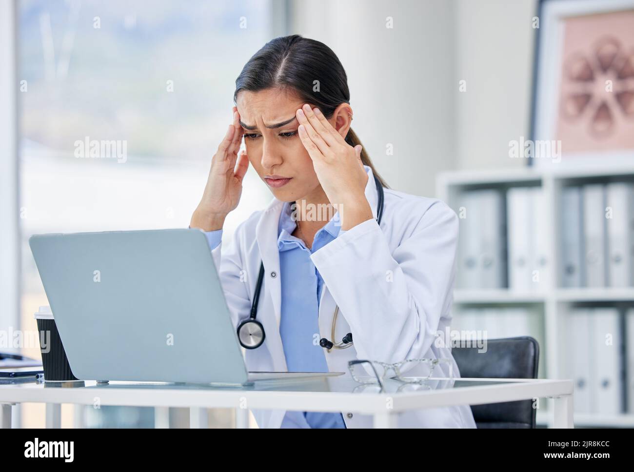 Stress or burnout with doctor thinking and working on laptop in ...