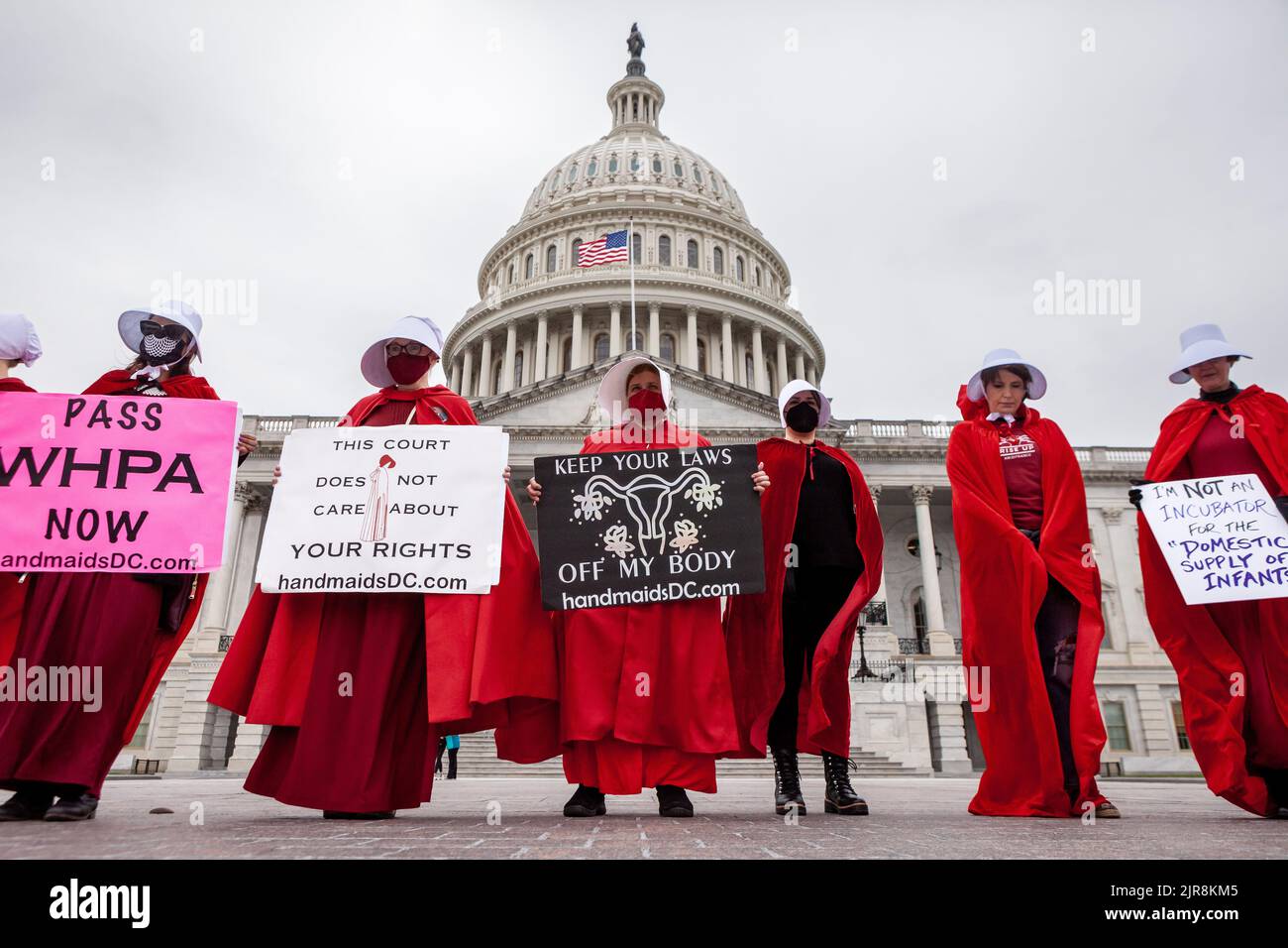 Demonstrators dressed as handmaids from The Handmaid's Tale, hold ...