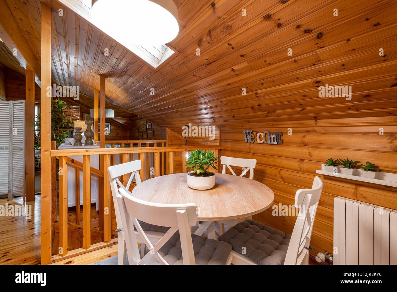 Round dining table with chairs on the second floor of completely wooden ...
