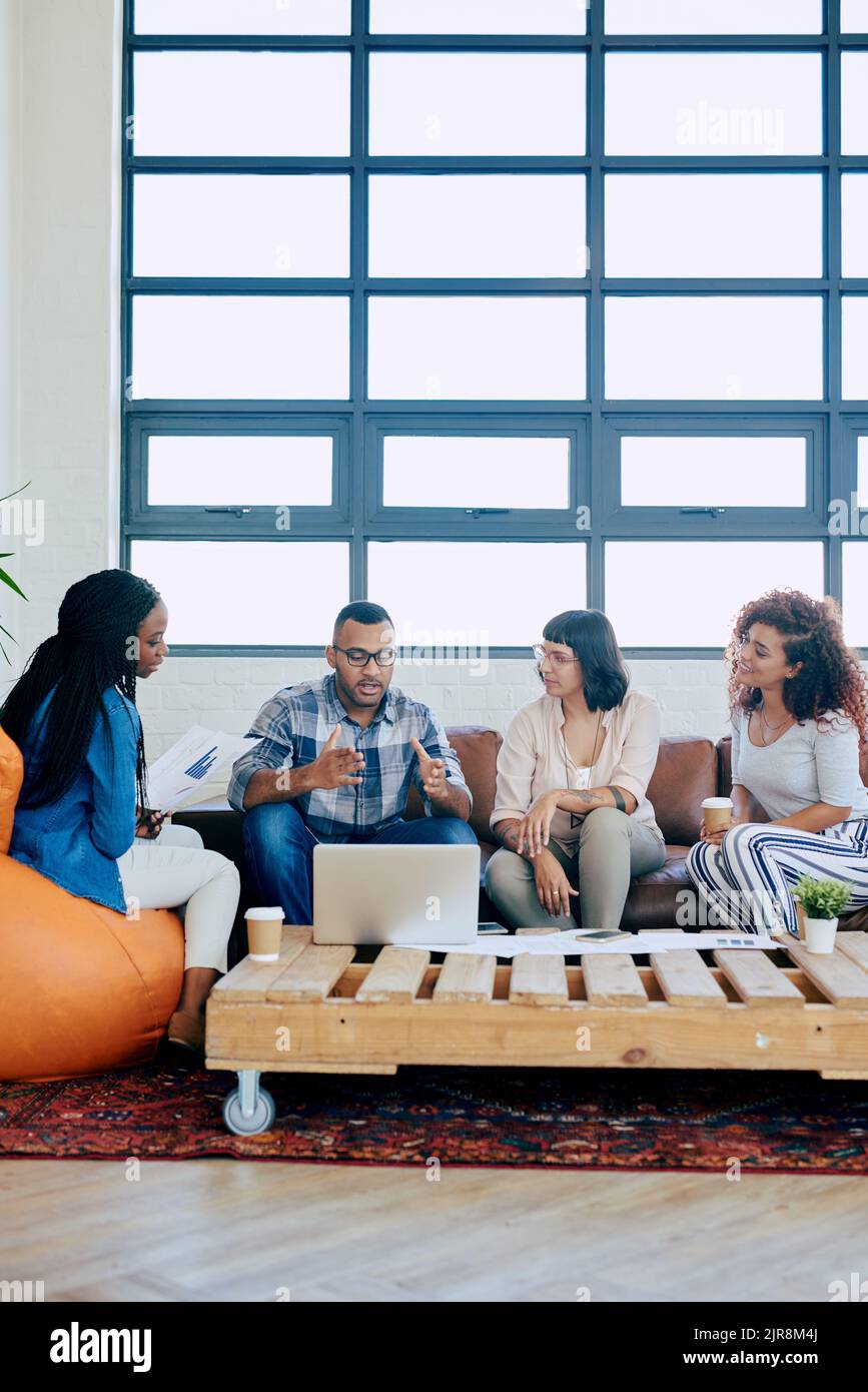 Exploring the possibilities. a group of colleagues using a laptop ...