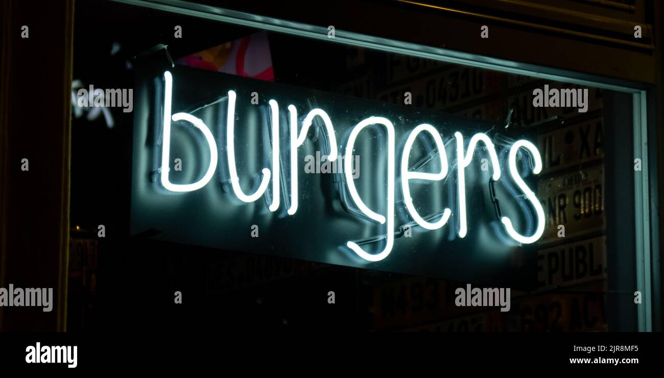 Burgers inscription in neon lights at night. Electric sign at night ...