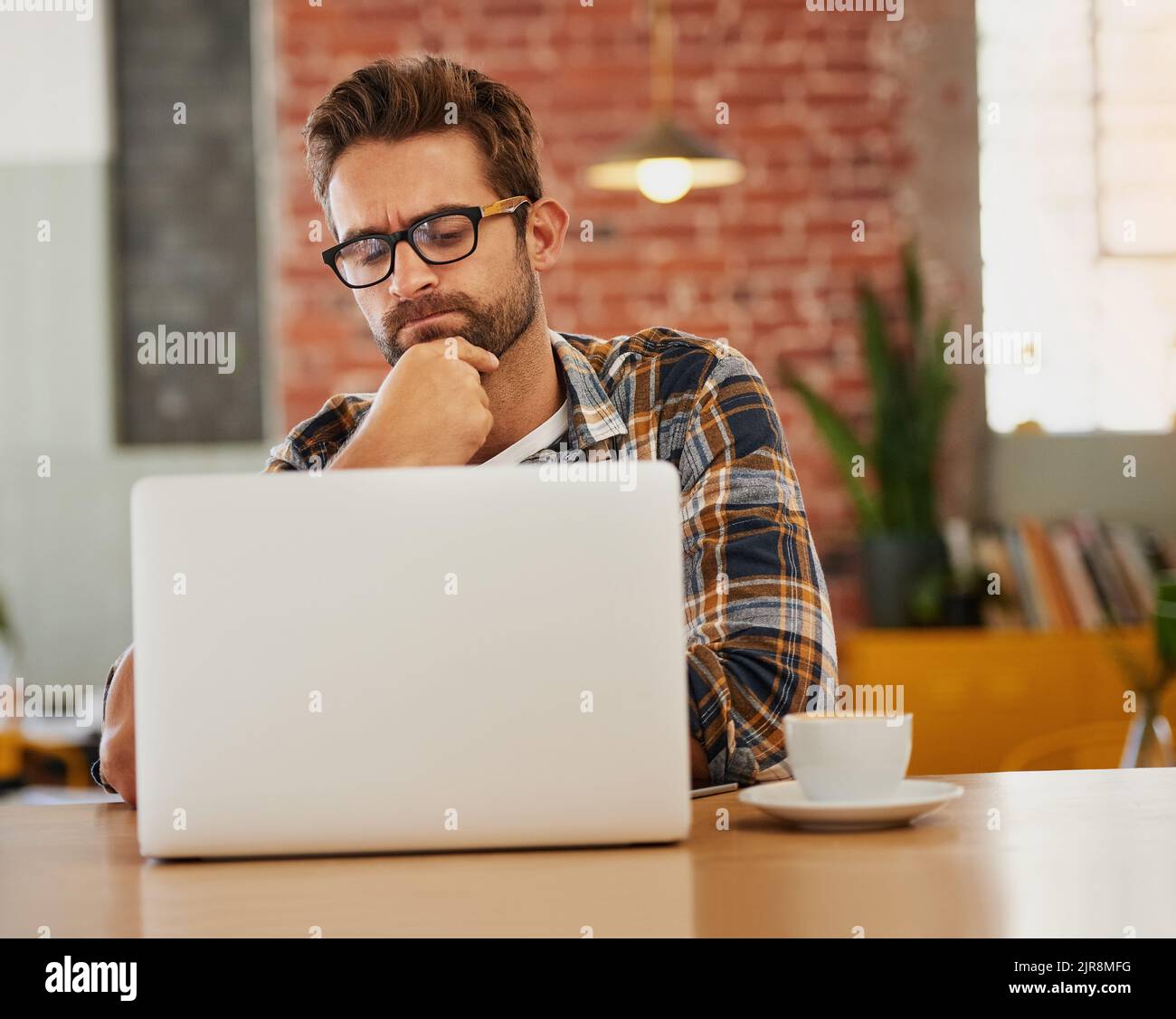 Wrapping his head around the issue. a young entrepreneur staring at his ...