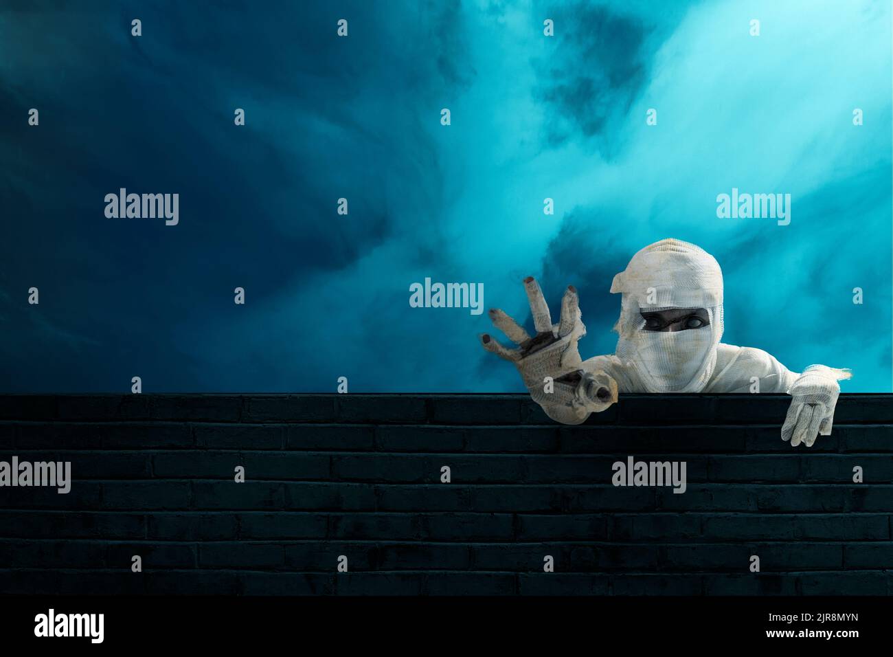 Mummy comes from behind the wall with a night scene background ...