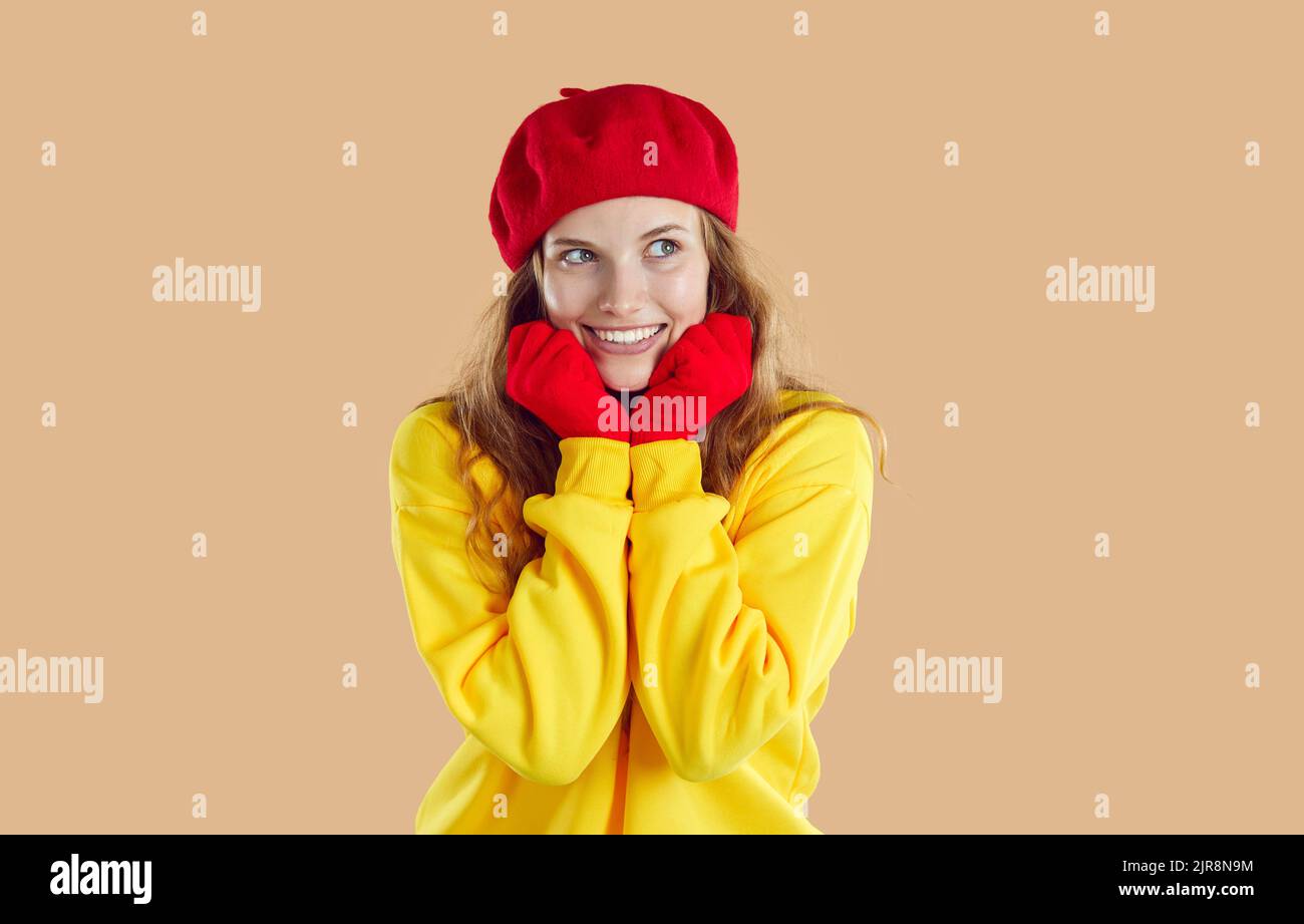 Happy smiling woman with dreamy facial expression isolated on light ...